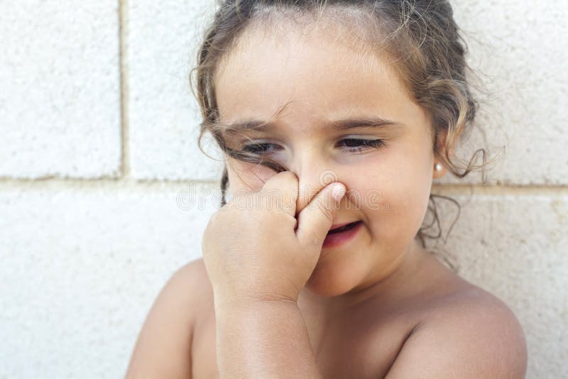Girl touching her nose. stock image. Image of face, stone - 68900575