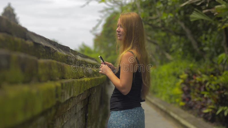 Girl Touching a Statue at a Waterfall in Bali Stock Footage - Video of ...