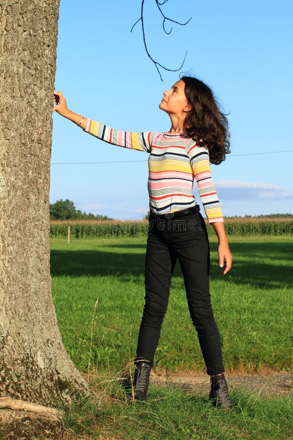 Girl touching a tree stock photo. Image of trunk, child - 167642032