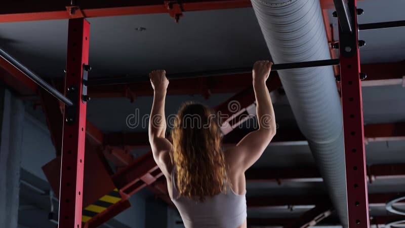 Girl Trains Middle Back and Lower Back in the Gym. Pull Ups Stock ...