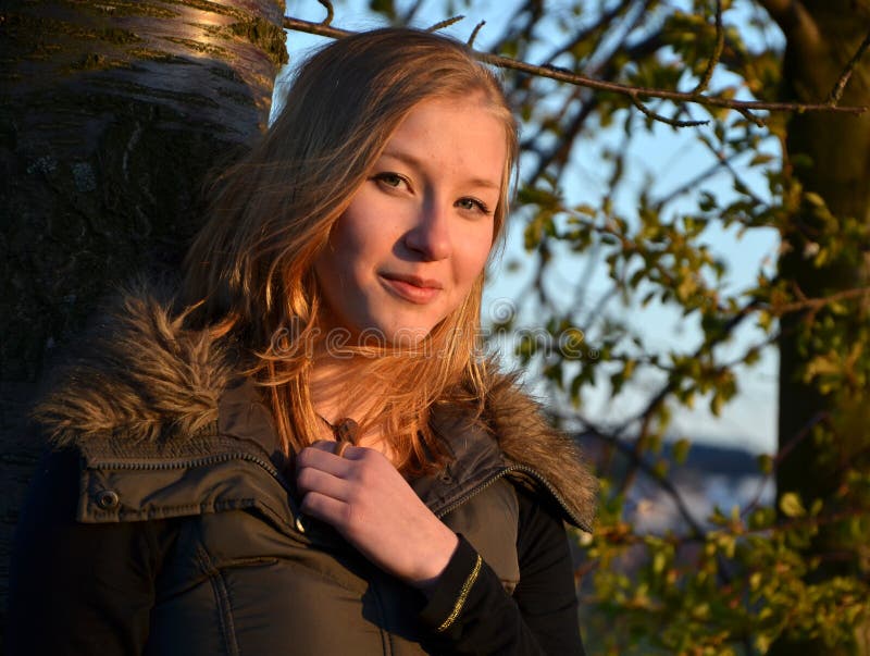Girl at tree stock image. Image of sunlight, fascination - 70694109