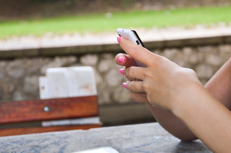 Girl typing on her phone stock photo. Image of white - 42616980