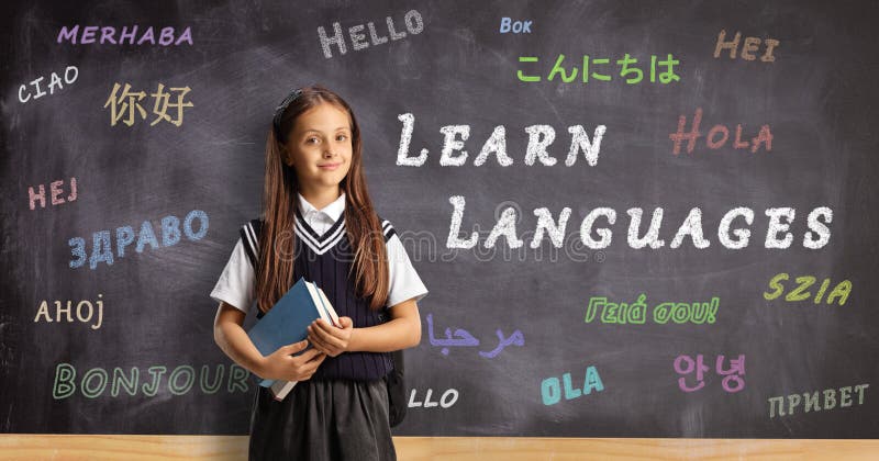 Girl in a School Uniform Holding a Book in Front of a Blackboard with ...