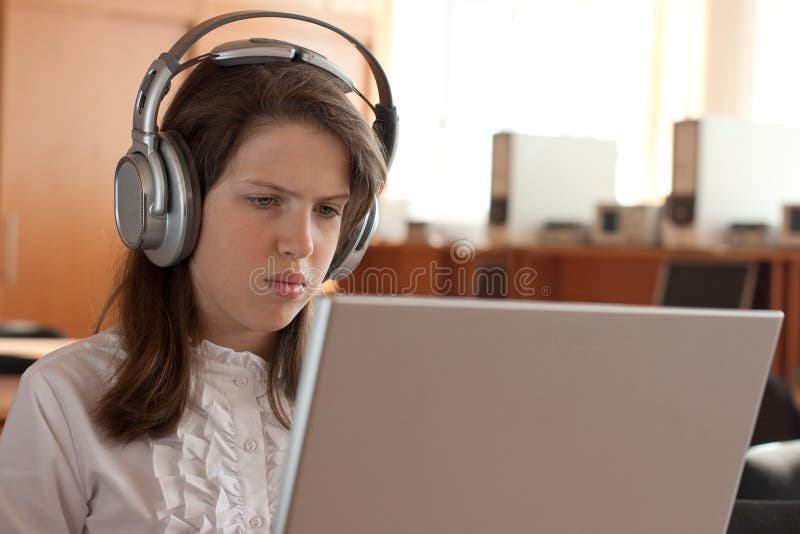 Girl is Using Computer with Headphones Stock Photo - Image of learning ...