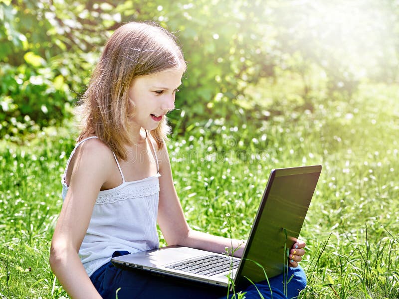 Girl with laptop on grass stock image. Image of leisure - 177186611