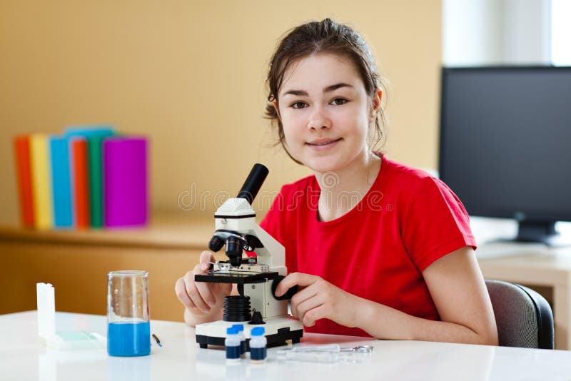 Girl using microscope stock photo. Image of classroom - 19821050