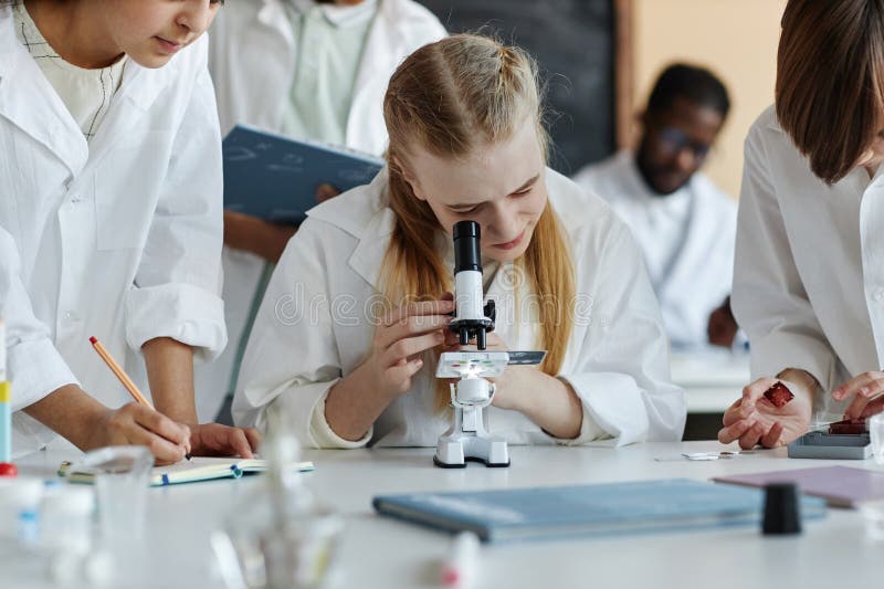 Girl Using Microscope during Lesson at School Stock Image - Image of ...