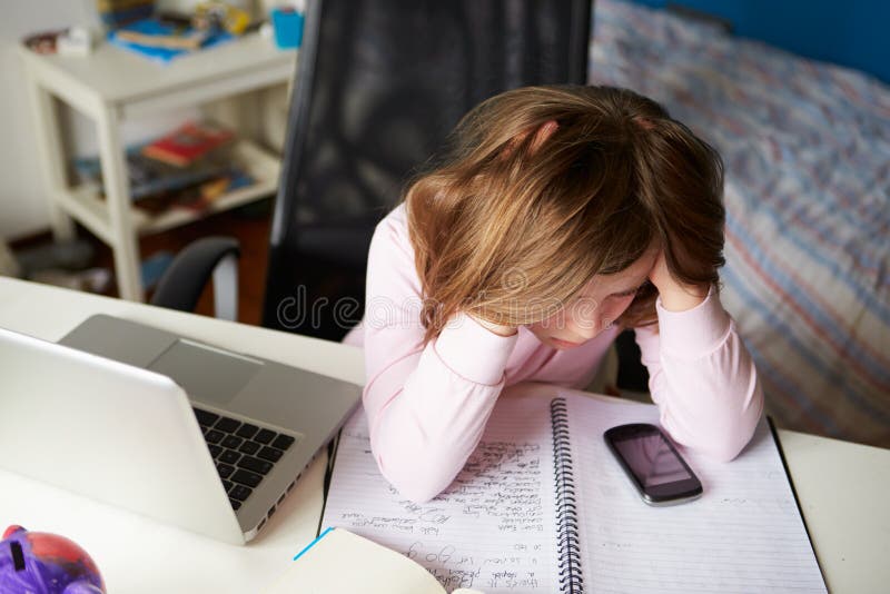 Girl Using Mobile Phone instead of Studying in Bedroom Stock Photo ...