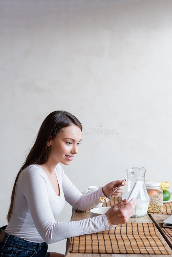 Girl Using Smartphone and Holding Spoon Stock Photo - Image of ...
