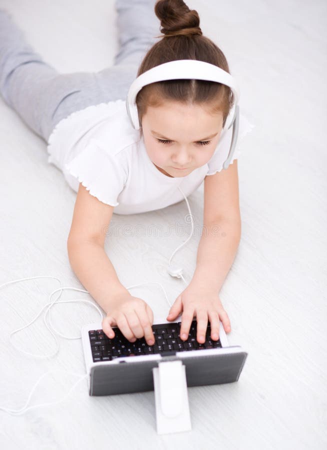 Girl using tablet stock photo. Image of human, lying - 38264466