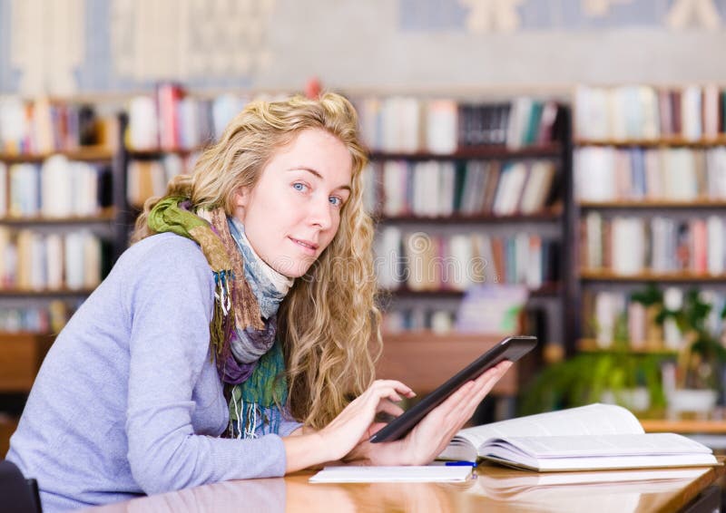 Girl Using a Tablet Computer in a Library Stock Image - Image of campus ...