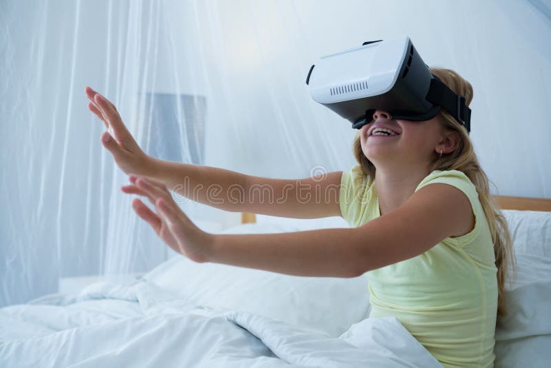 Girl Using Virtual Reality Simulator while Sitting on Bed Stock Image ...