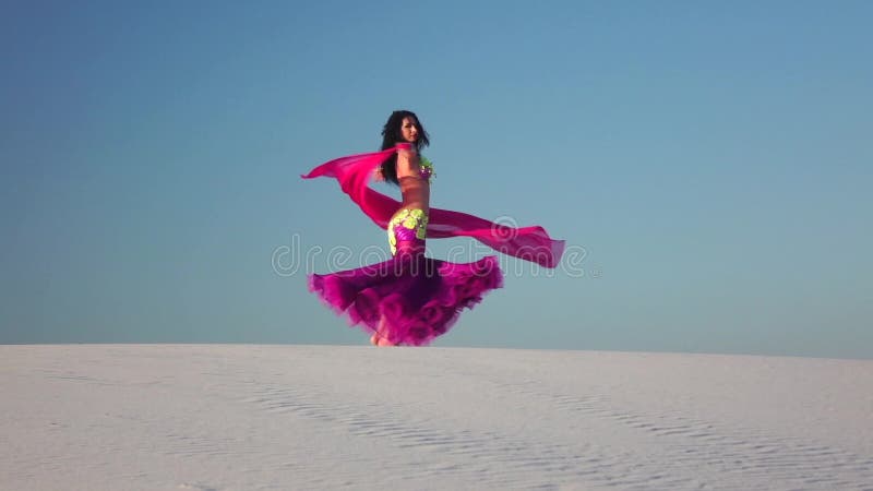 Girl with a Veil in Her Hands Dances a Belly Dance in the Desert. Slow ...