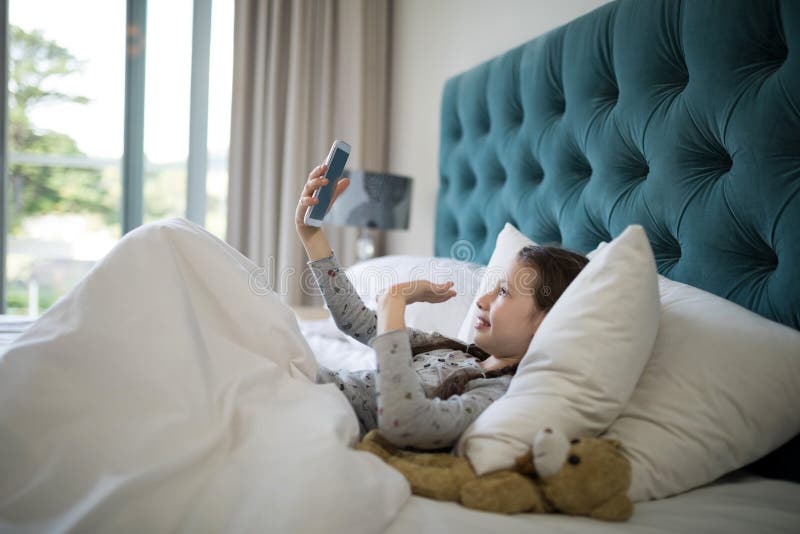 Girl Video Calling On Mobile Phone In Bedroom Stock Image - Image of ...