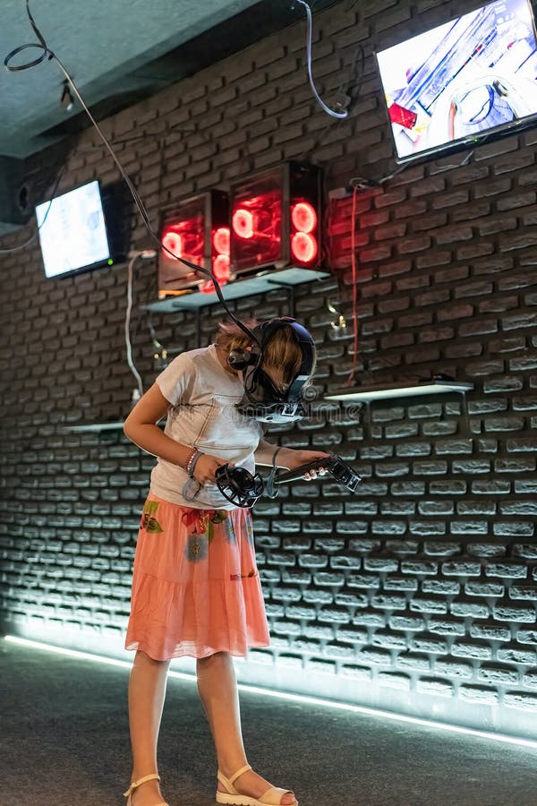 A Girl in a Virtual Reality Helmet with Joysticks Plays Computer 3D ...