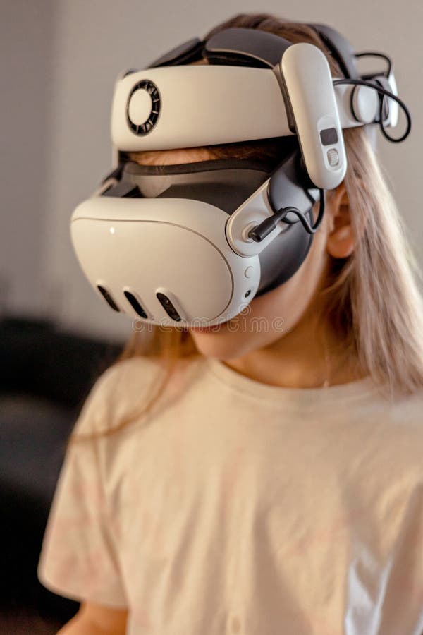 Girl in VR Glasses Playing Game at Home. Learning and Playing with Augmented Reality Glasses ...