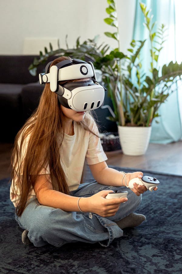 Girl in VR Glasses Playing a Game at Home. Learning and Playing with Augmented Reality Glasses ...