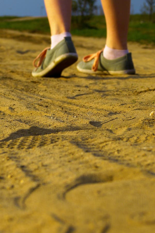 Girl Walking Away in the Sand Stock Image - Image of trails, footprints ...
