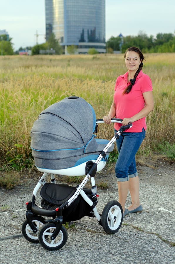 Girl Walking with a Baby Stroller in the Street Stock Photo - Image of ...