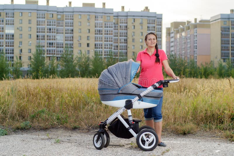 Girl Walking with a Baby Stroller in the Street Stock Photo - Image of ...