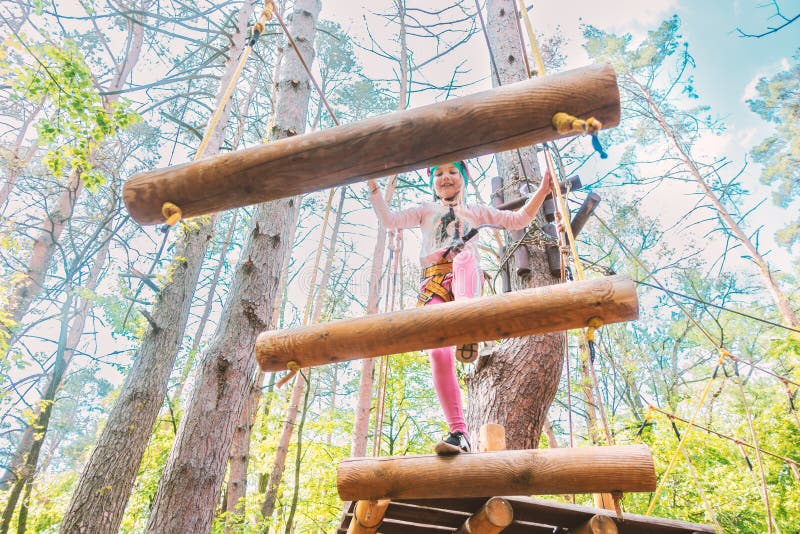 A Girl Walks on a Rope Ladder Overcoming an Obstacle Stock Image ...