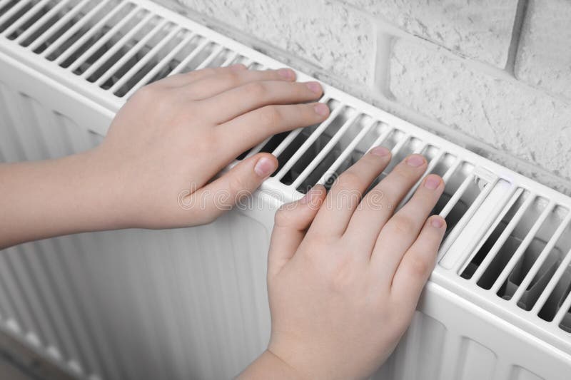 Girl Warming Hands on Heating Radiator Indoors, Closeup Stock Image ...