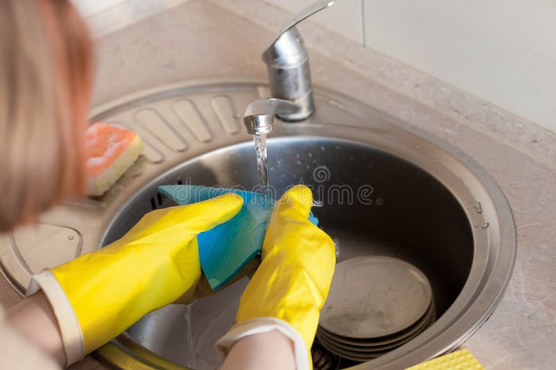 A Girl Washes a Plate with a Rag and a Sponge in the Kitchen. the Plot ...