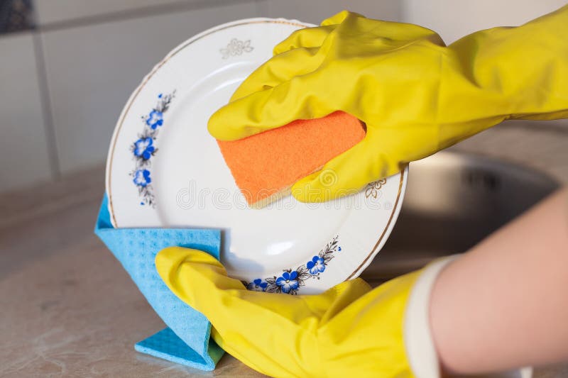 A Girl Washes a Plate with a Rag and a Sponge in the Kitchen. the Plot ...