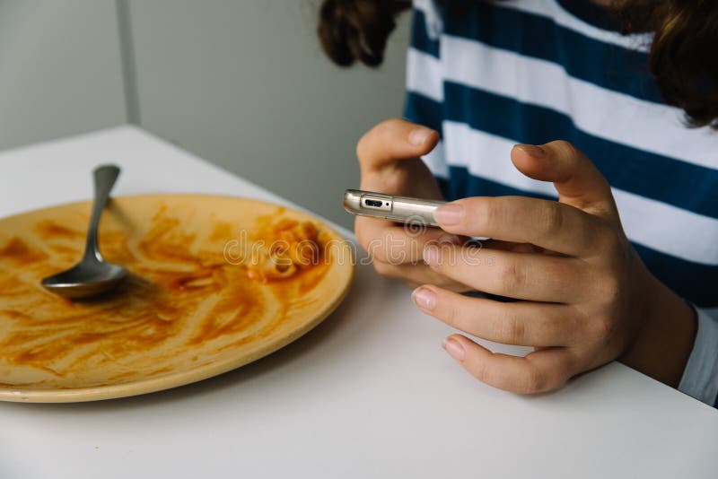 Girl Watching Her Smartphone Sitting at the Table Stock Image - Image ...