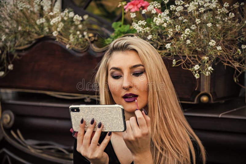 Girl Watching Makeup Tutorial Video. Lipstick on Lips. Cosmetics and ...