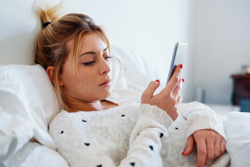 Girl Watching Phone Screen in Her Bedroom Stock Photo - Image of ...