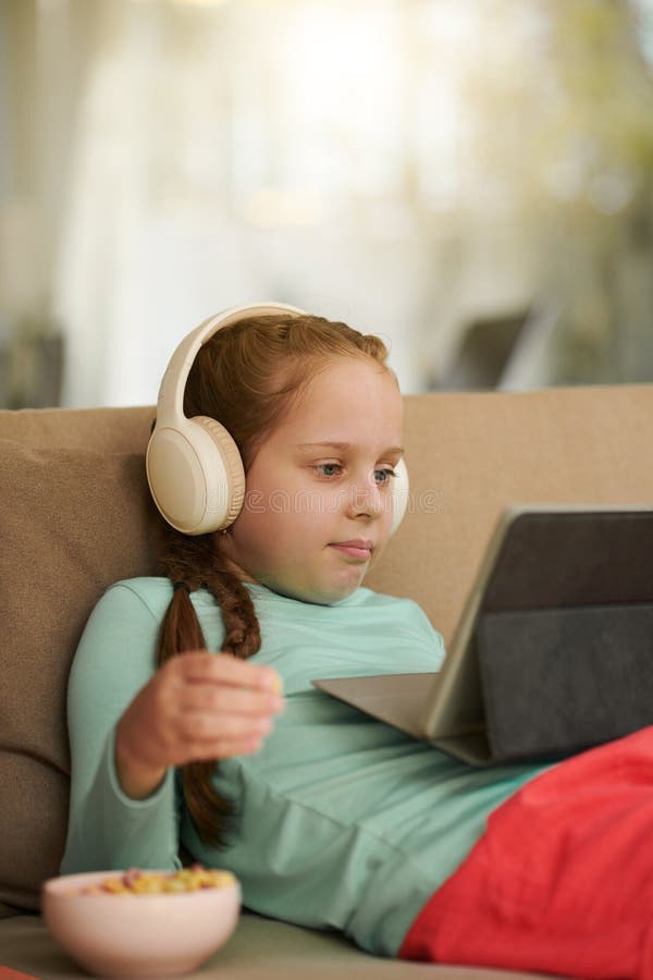 Girl Watching Videos on Tablet Stock Image - Image of girl, sofa: 274511063