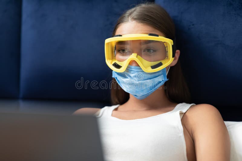 Girl Wearing Protective Mask Using Laptop Working Remotely in Bed Stock ...
