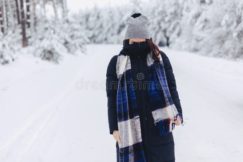 A Girl Wearing a Winter Hat Poses on a Camera in the Background Stock ...