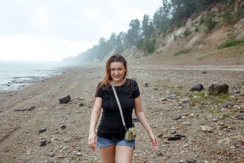 The Girl in Wet Clothes Walking Under a Heavy Rain Outdoors Stock Image ...