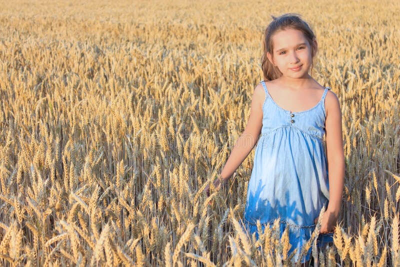 Girl in the wheat stock image. Image of cheerful, blue - 25504233