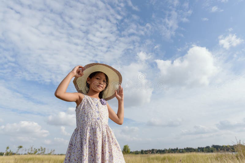 A Girl Who Wearing a Straw Hat in a Field in Summer Stock Image - Image ...