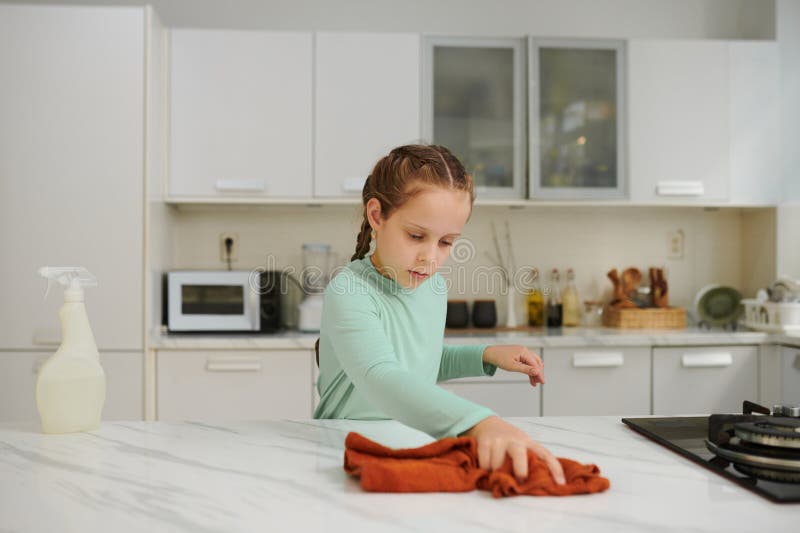 Girl Wiping Kitchen Counter Stock Photo - Image of lifestyle, childhood ...