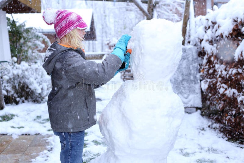 Girl is Working on a Snowman Stock Image - Image of snowfall, frost ...