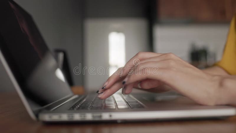 The Girl Works at Home at the Computer and Types Text on the Keyboard ...