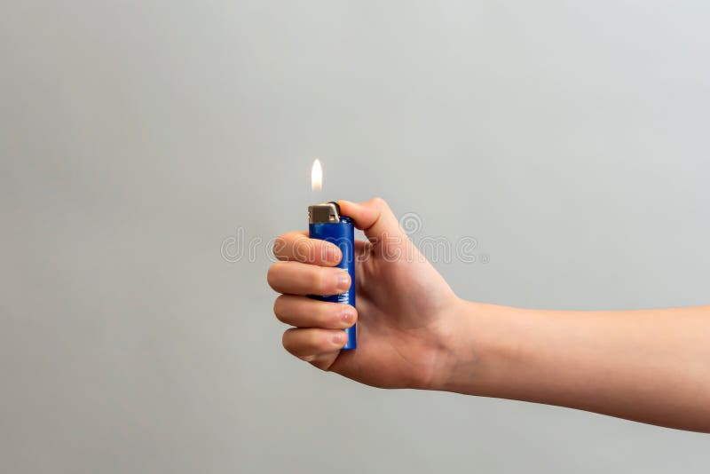 The Girl Wrapped Her Hand Around the Lighter and Lit Her Finger on a ...