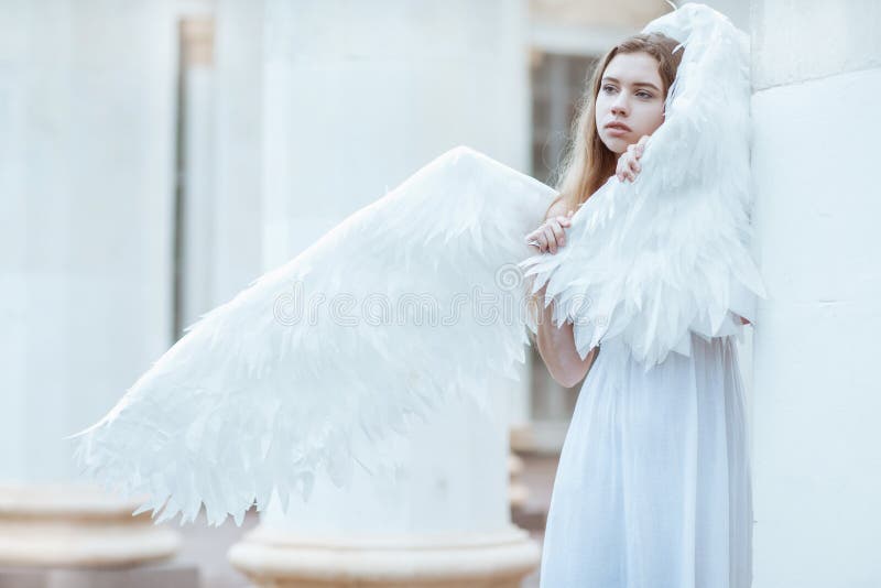 Girl wrapped in a wing stock image. Image of feminine - 71114869