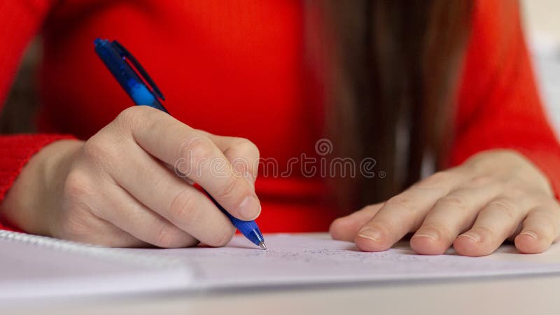 A Girl Writes with a Pen in a Notebook Stock Photo - Image of desk ...