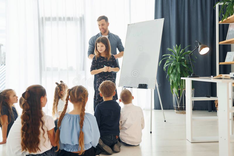 Girl Writing on the Board. Group of Children Students in Class at ...