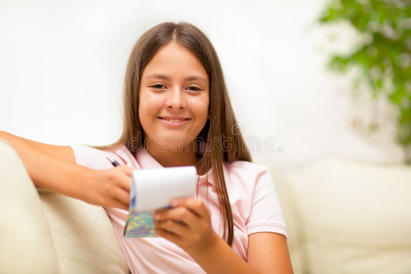 Girl Writing in a Diary Sitting Stock Image - Image of looking, teen ...