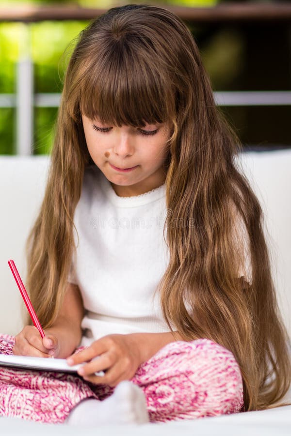 Girl Writing at Her Notepad Stock Image - Image of outdoors, pencil ...
