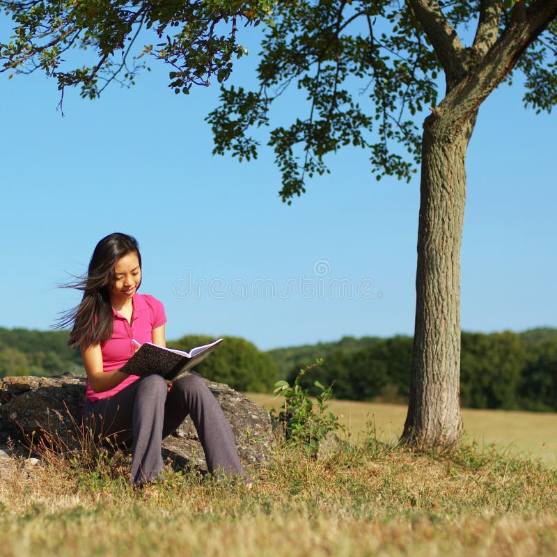 Girl Writing in Note Book stock image. Image of meadow - 6253677