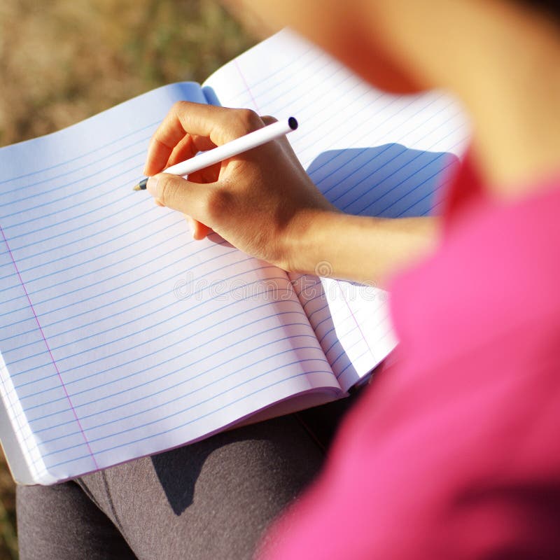 Girl Writing in Note Book stock image. Image of meadow - 6253677