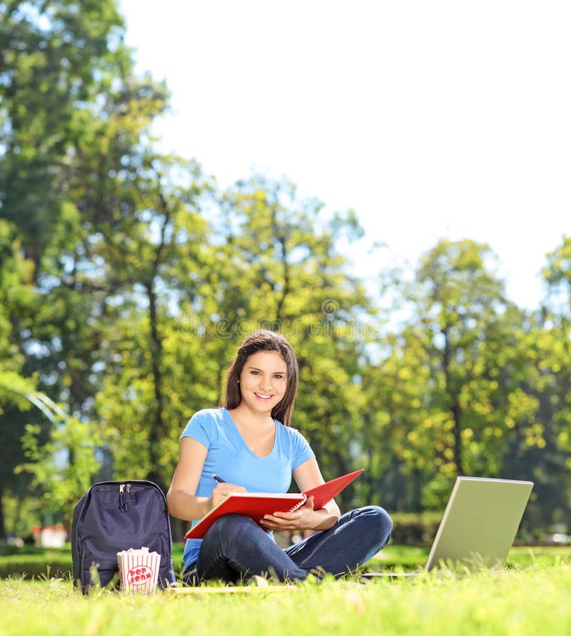 Girl Writing in a Notebook Outdoors Stock Photo - Image of seated, pose ...