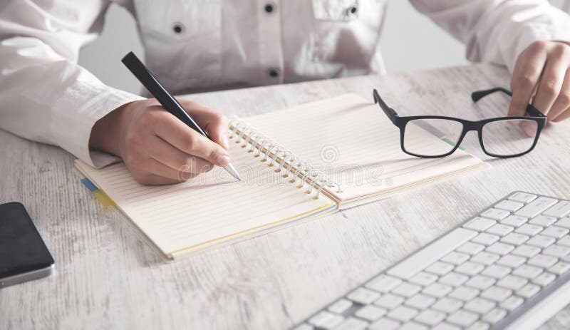 Girl Writing on Notepad in Office Desk Stock Photo - Image of notepad ...